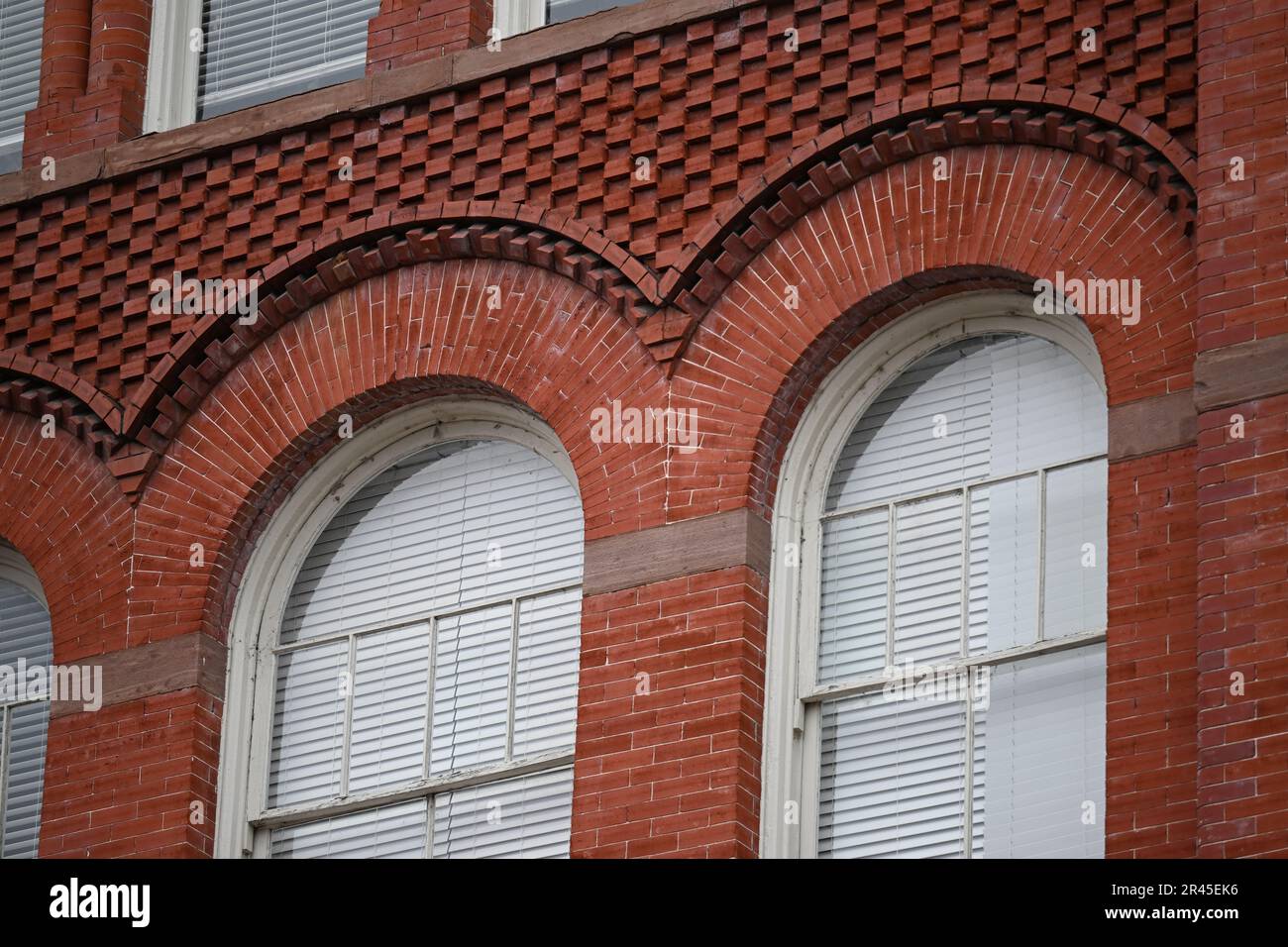An exterior of an old building in an urban area with arched windows ...
