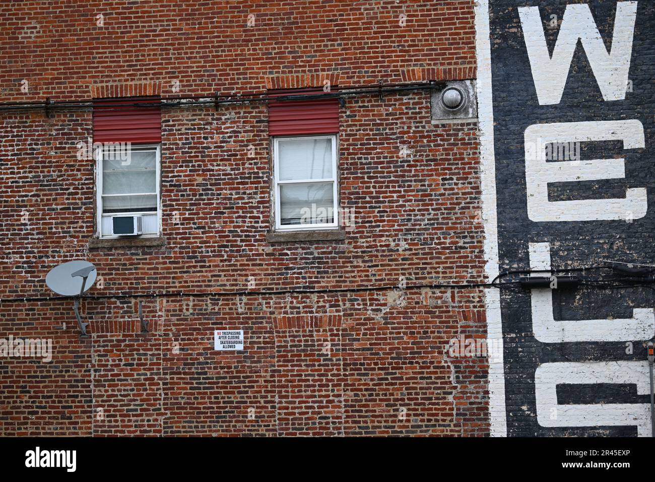 An old, abandoned brick building with a weathered sign Stock Photo - Alamy