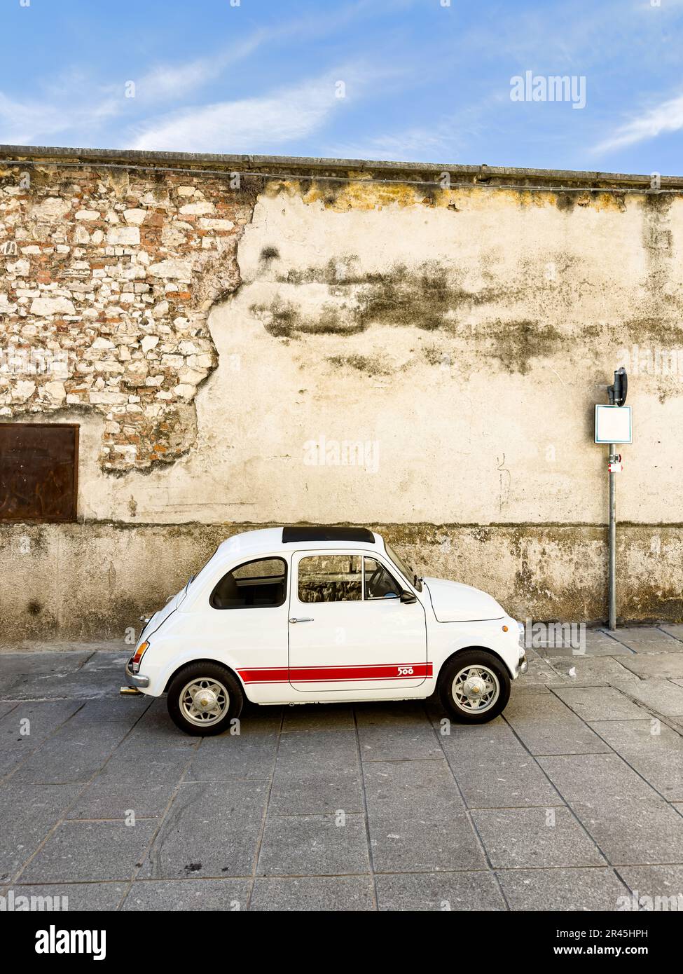 A vintage cream coloured car parked in an ancient Italian village Stock ...