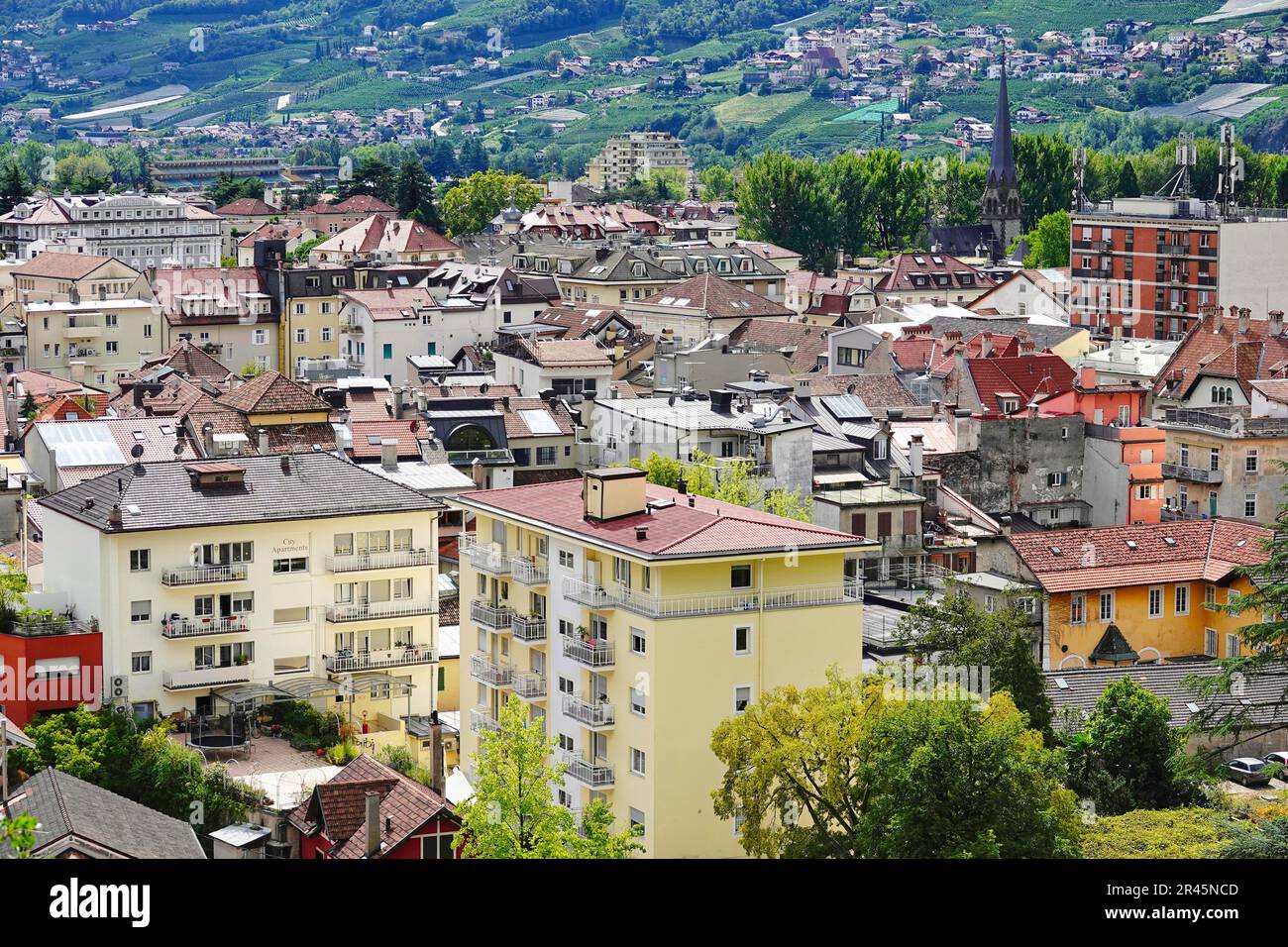An aerial view of an urban landscape with tall buildings in the rolling ...