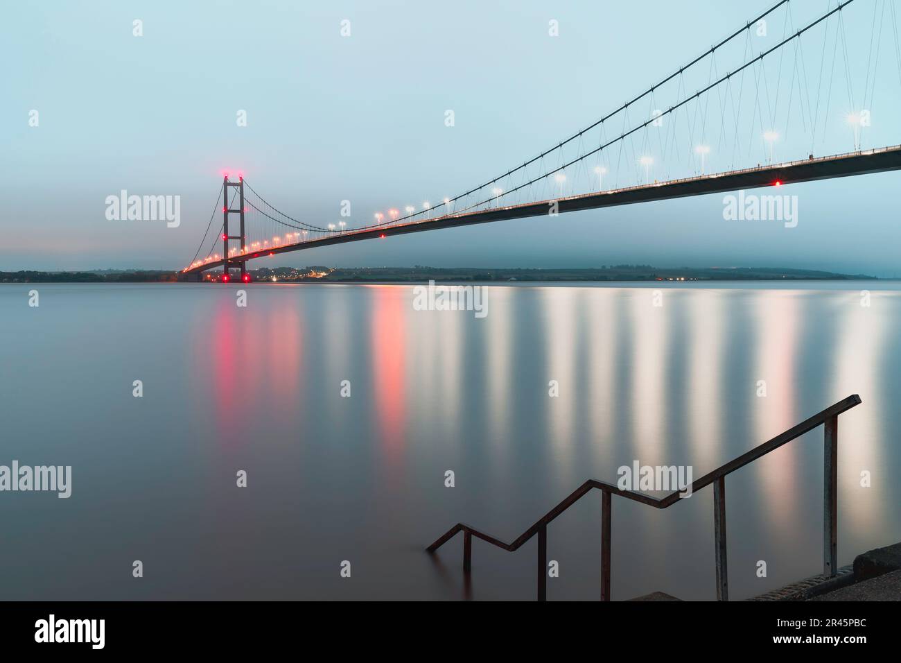 The Humber bridge lit up by bright colorful lights reflecting on the ...