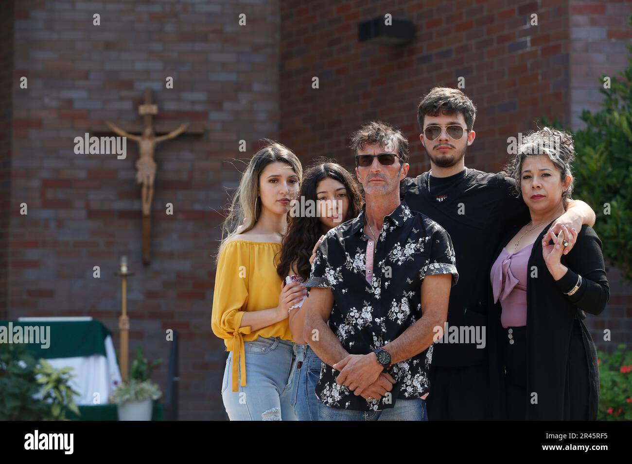 Jose Villalobos (center) stands for a portrait with his wife Maria ...