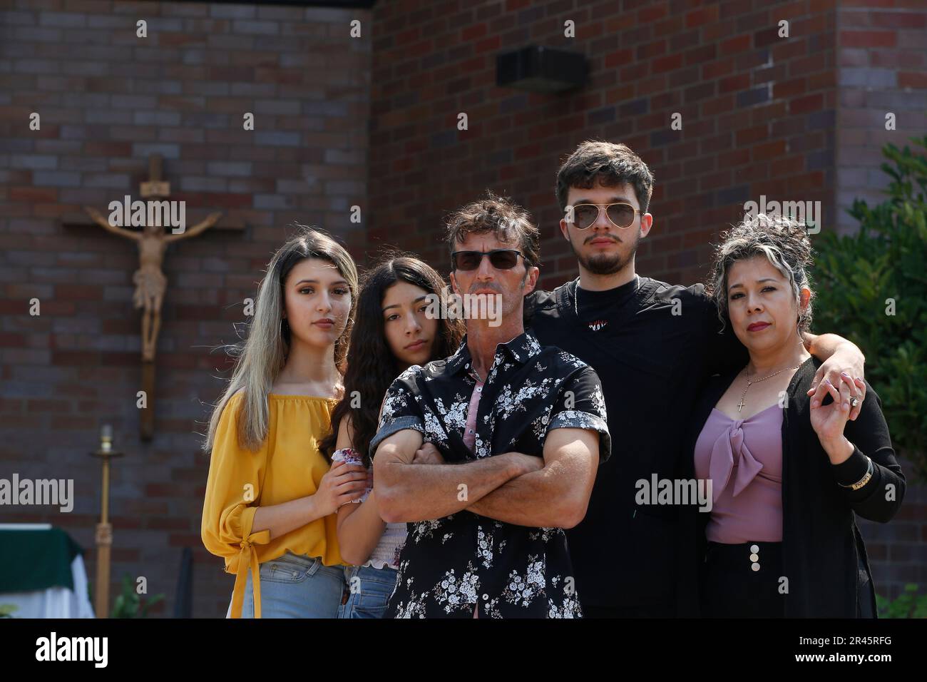 Jose Villalobos (center) stands for a portrait with his wife Maria ...