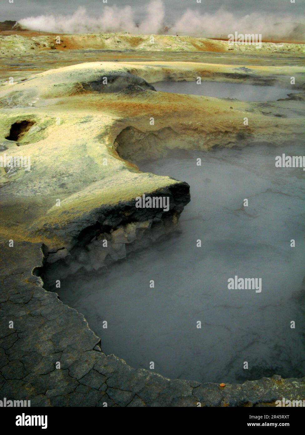 A serene view of a tranquil hot spring surrounded by stunning rocks and ...