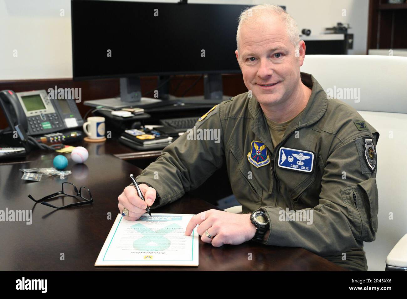 U.S. Air Force Col. Daniel Diehl, 509th Bomb Wing commander, signs a ...
