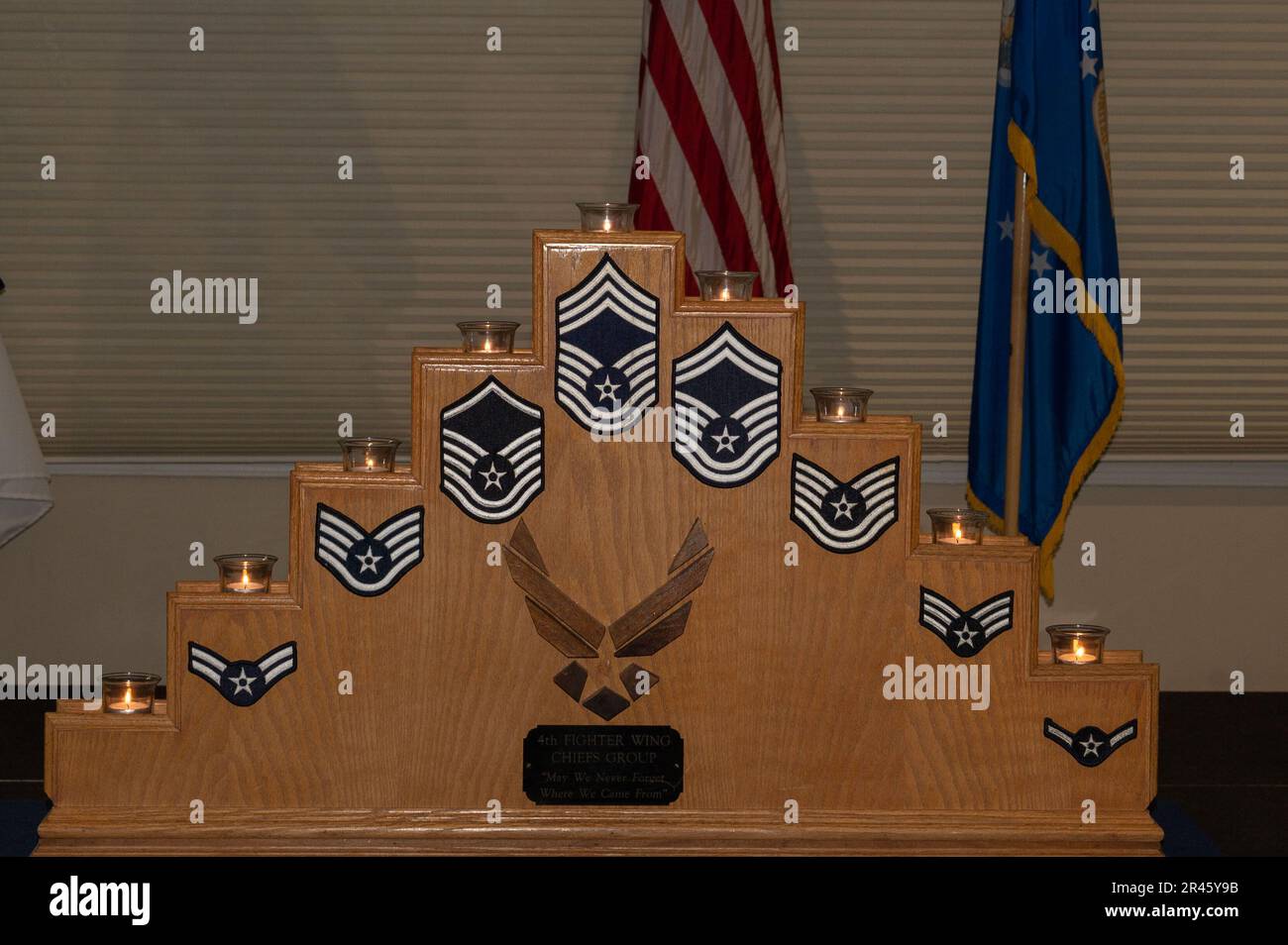Candles representing each enlisted rank are lit on a podium during a ...