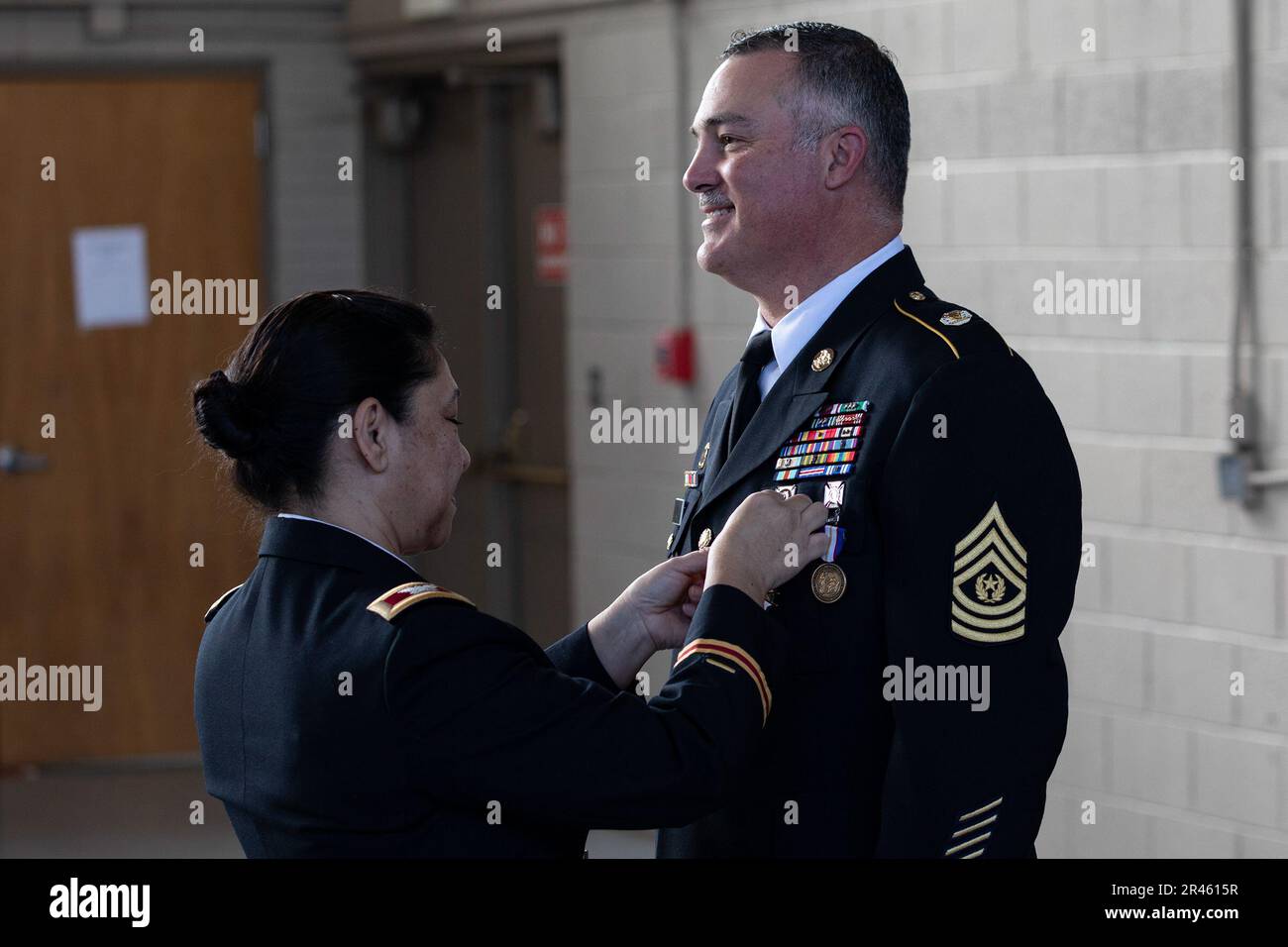 Command Sgt. Maj. Randy Ly, right, completes his last official duty for ...