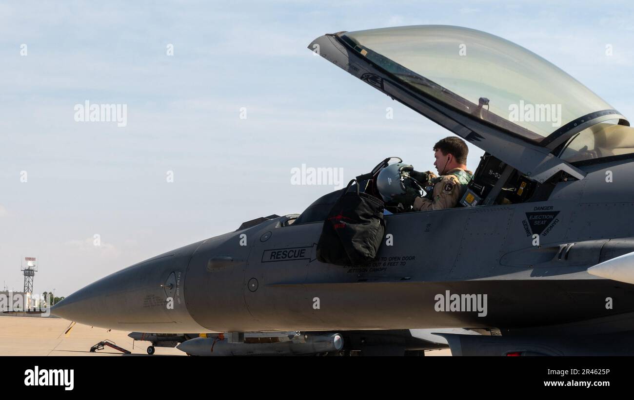 U.S. Air Force Capt. Patrick O'Shea dons his helmet in the cockpit of ...