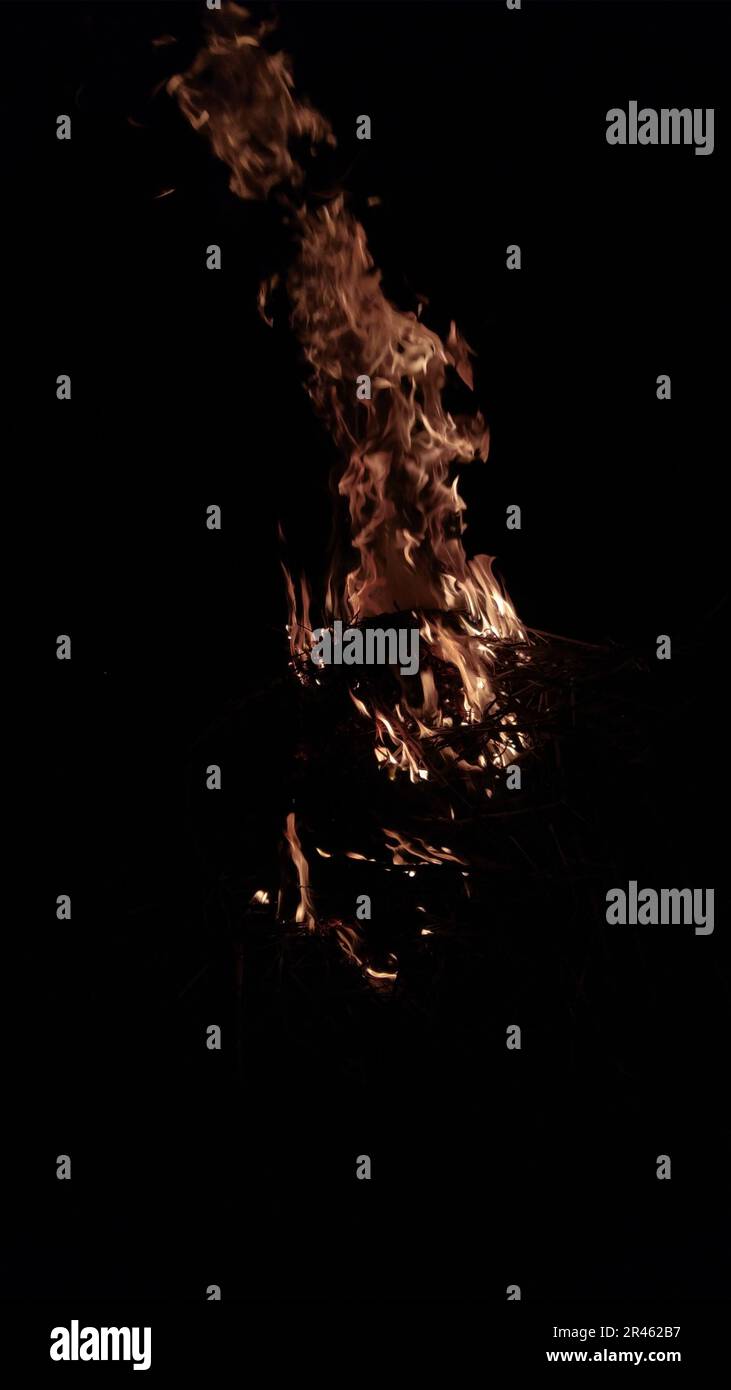 A black background with orange flames and smoke billowing outwards ...