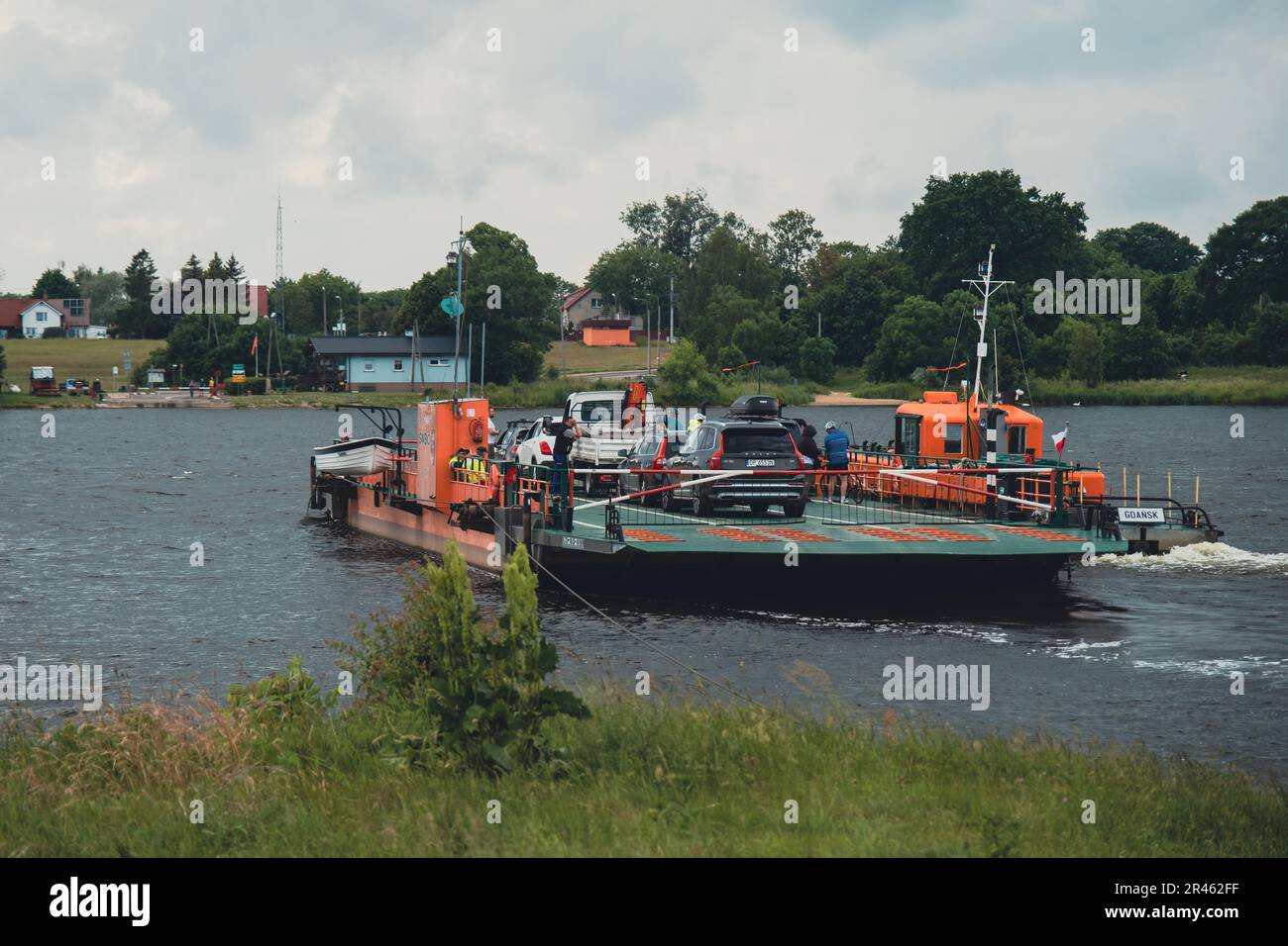 A Ferry boat transporting cars and crossing the Wisla river near Gdansk ...