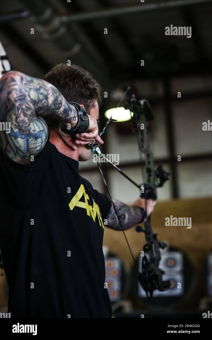 U.S. Army Master Sgt. Michael Haley, prepares to shoot his arrow during ...