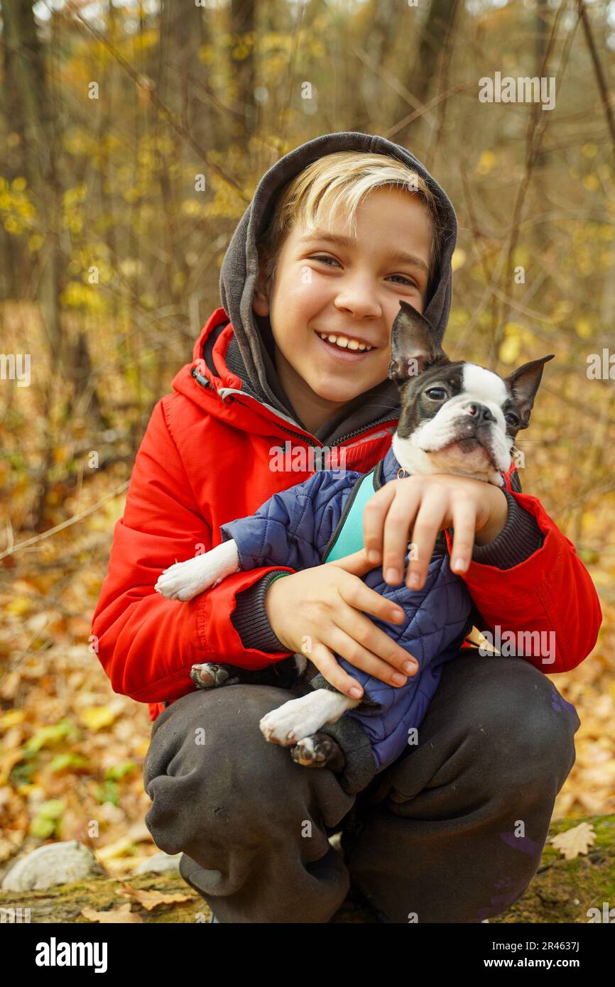 A boy playing with his dog in the park Stock Photo - Alamy
