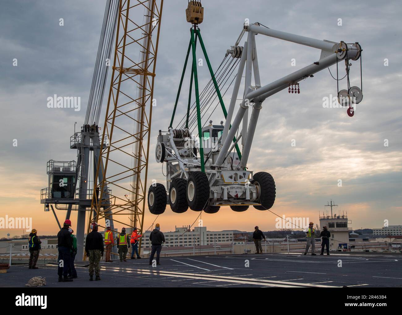 A crane prepares to lower the first-in-class aircraft carrier USS ...