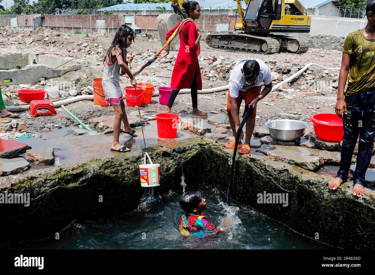 Dhaka, Bangladesh. 26th May, 2023. Children are bathing and washing clothes from water lines ...