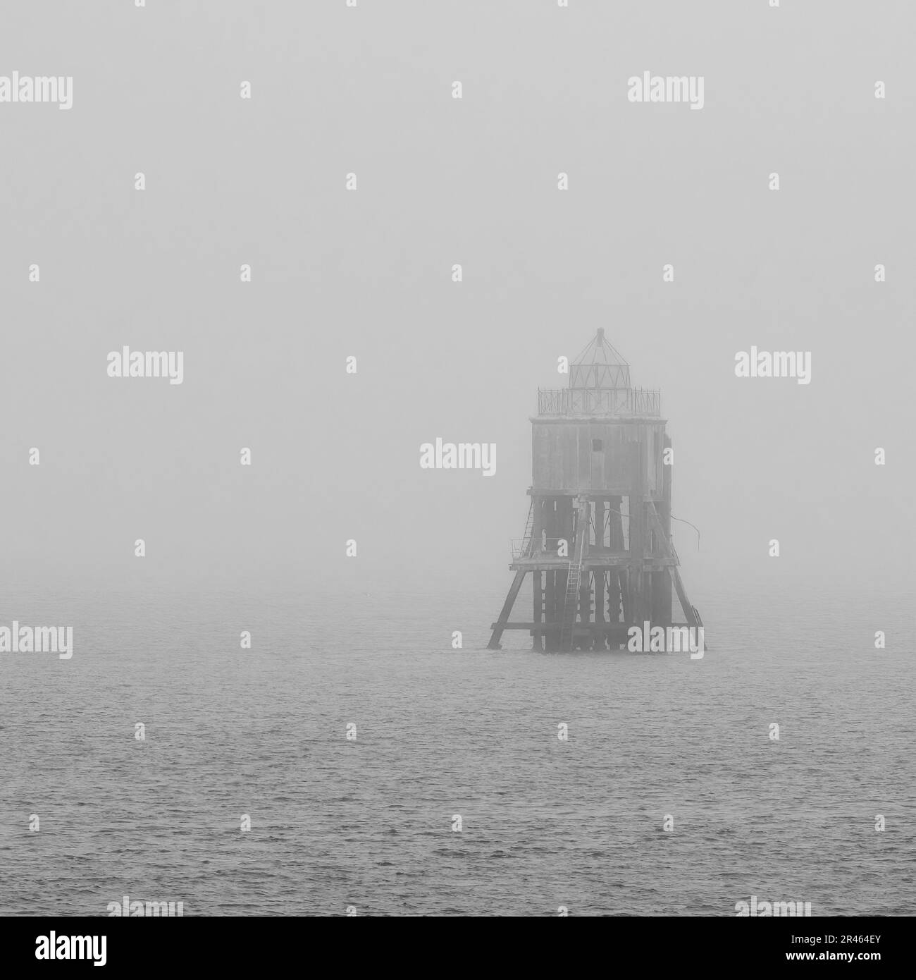 A grayscale shot of a lighthouse in the fog near river Tay Stock Photo ...