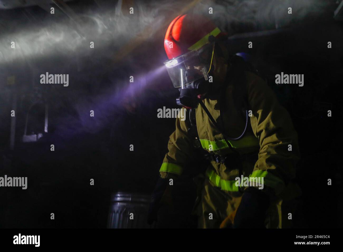 Seaman Cole Mack participates in a firefighting evolution during a ...