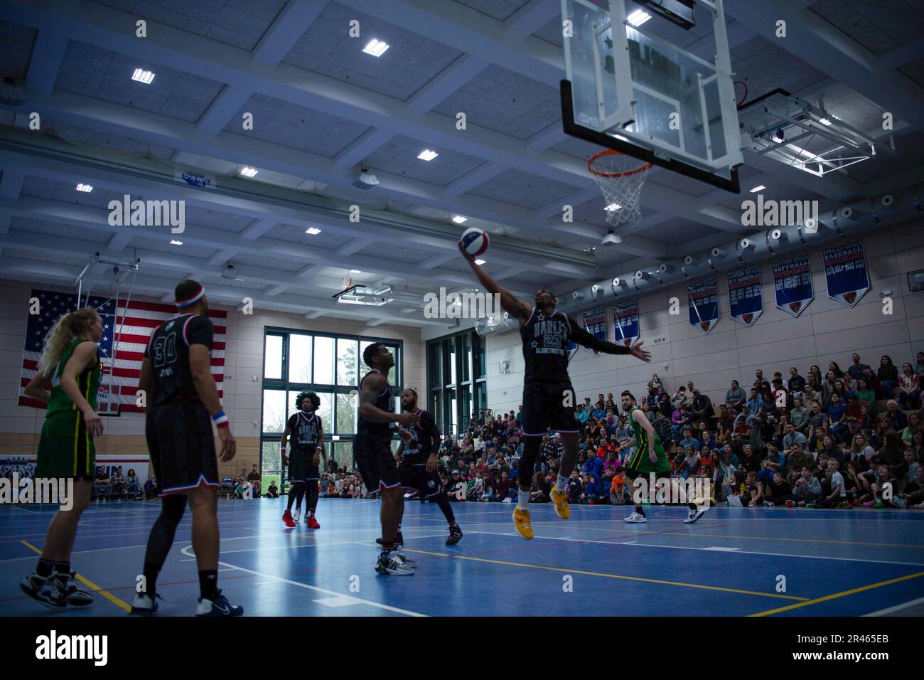 A Harlem Globetrotters player dunks a basketball at Ramstein Air Base ...