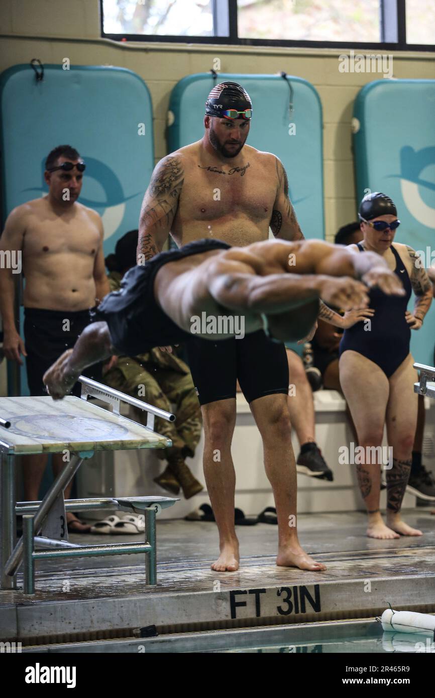 U.S. Army Athletes, watching as a fellow competitor dives into the pool ...