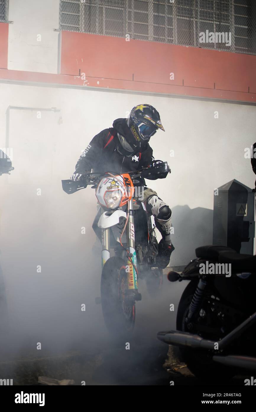The biker on a motorcycle raising a cloud of smoke Stock Photo - Alamy