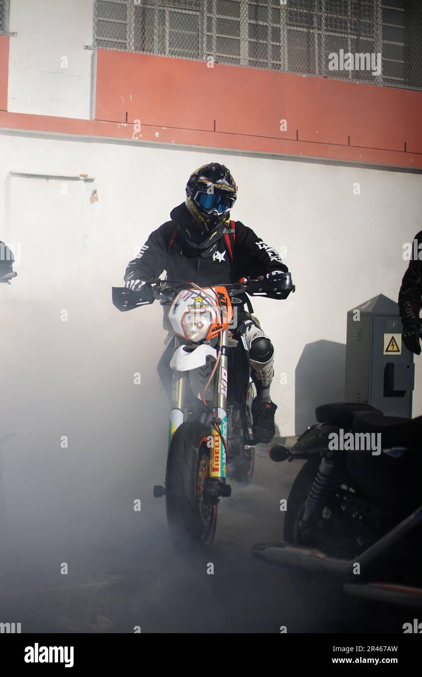 The biker on a motorcycle raising a cloud of smoke Stock Photo - Alamy