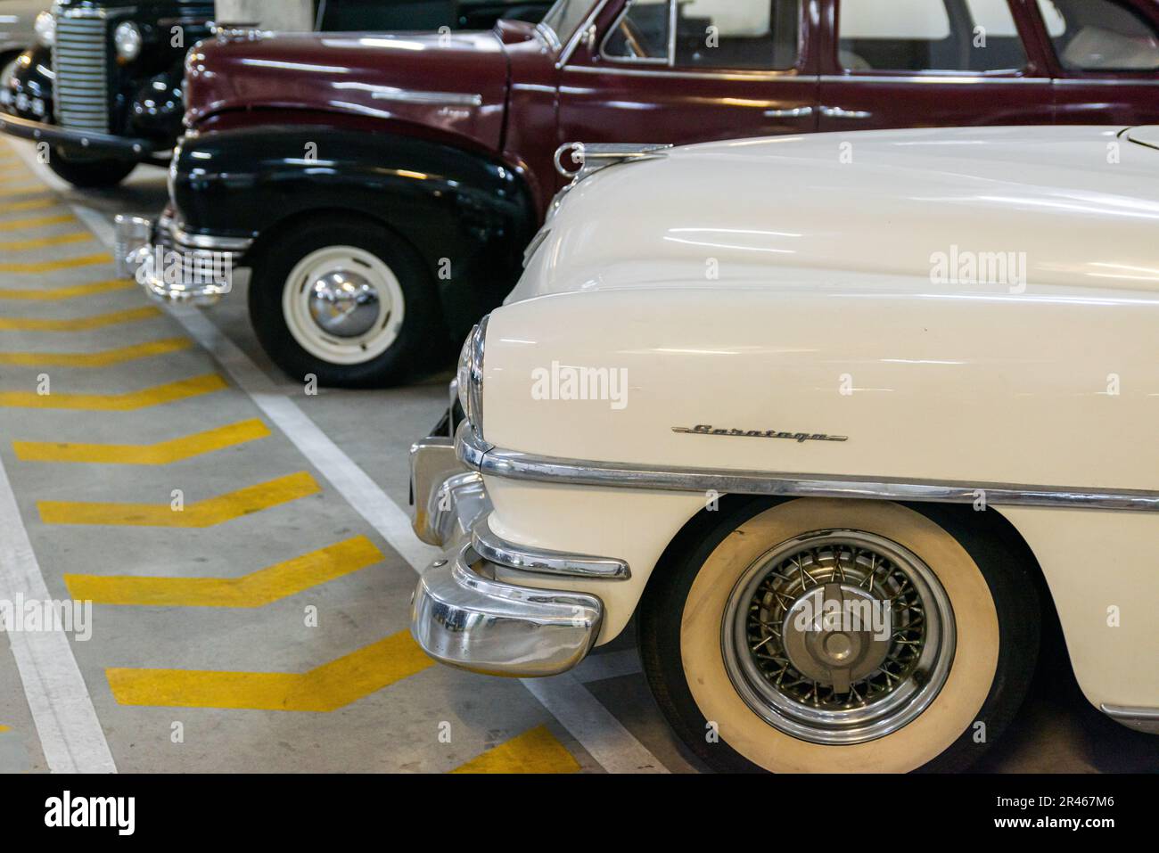 An aligned line of various historic cars with various brands and colors ...