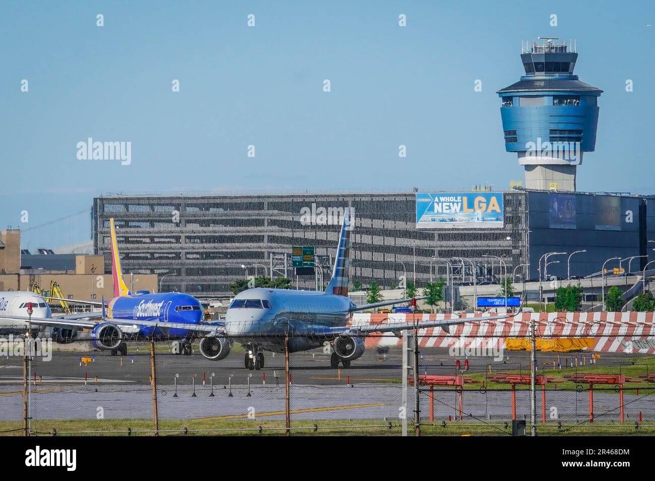 LaGuardia Airport's air traffic control tower, right, is shown as ...