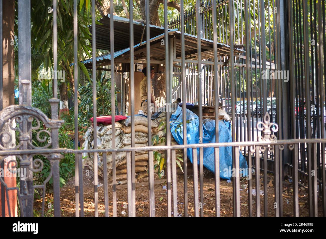 The policeman standing behind the metal bars in Mumbai, India Stock ...