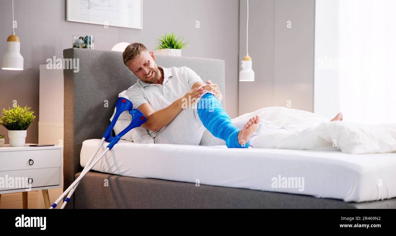 Man With Broken Leg Fracture Injury And Cast Using Crutches Stock Photo ...