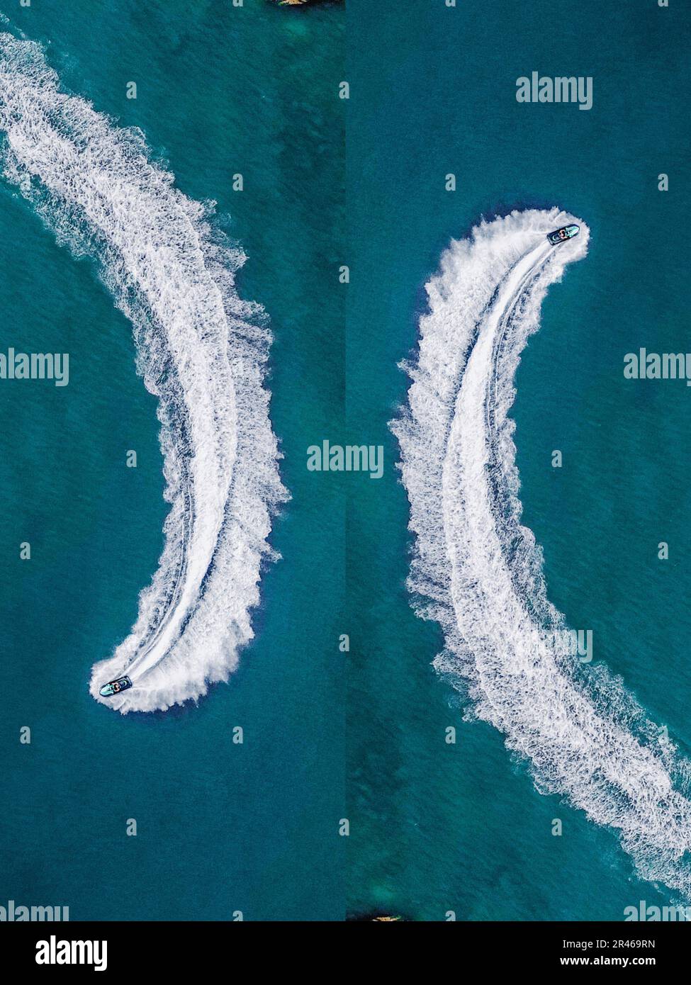 A vertical aerial view of two boats sailing in opposite directions on ...