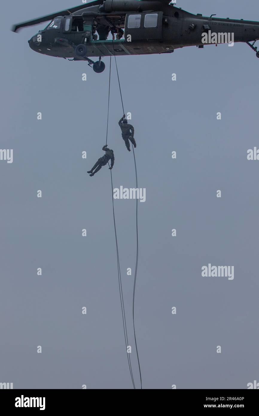 Two Soldiers rappel down from a UH-60 Black Hawk during Rappel Master ...