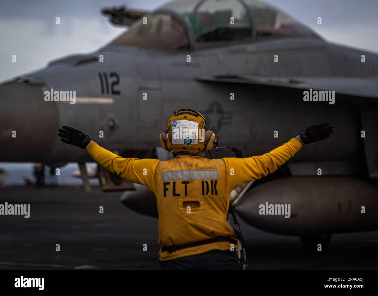 230406-N-MH015-2035 EAST CHINA SEA (April 6, 2023) A U.S. Navy Sailor directs an F/A-18F Super ...