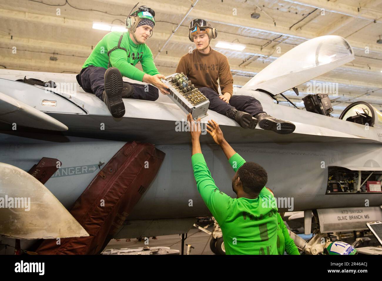 Aviation ElectricianÕs Mate 3rd Class Inza Diomande, from Ivory Coast, passes a power ...
