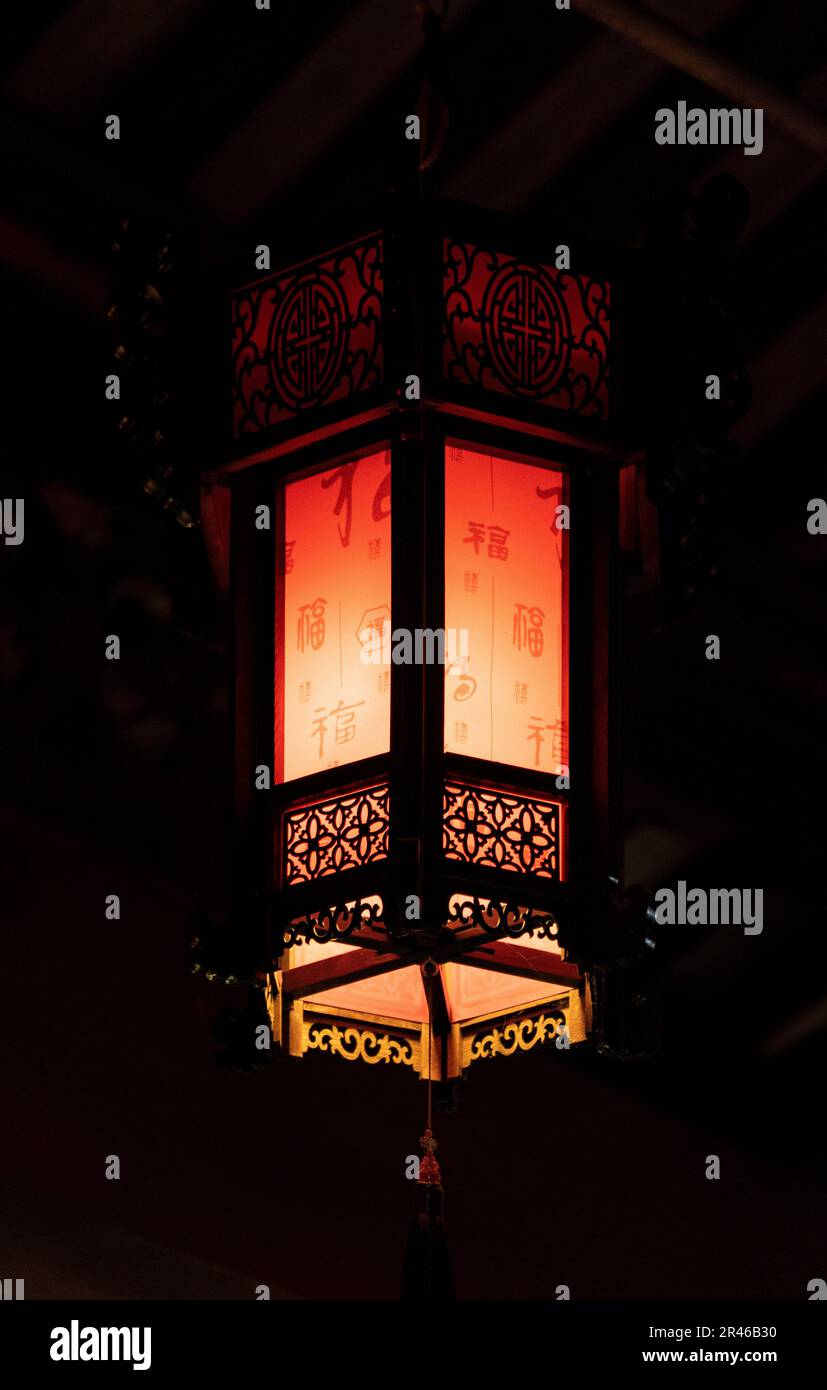 This image features a vibrant hexagonal lantern illuminated in the dark ...