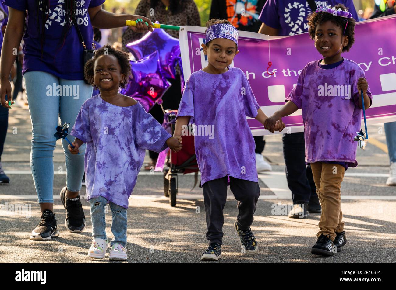 U.S. military children hold hands and walk in the Month of the Military ...