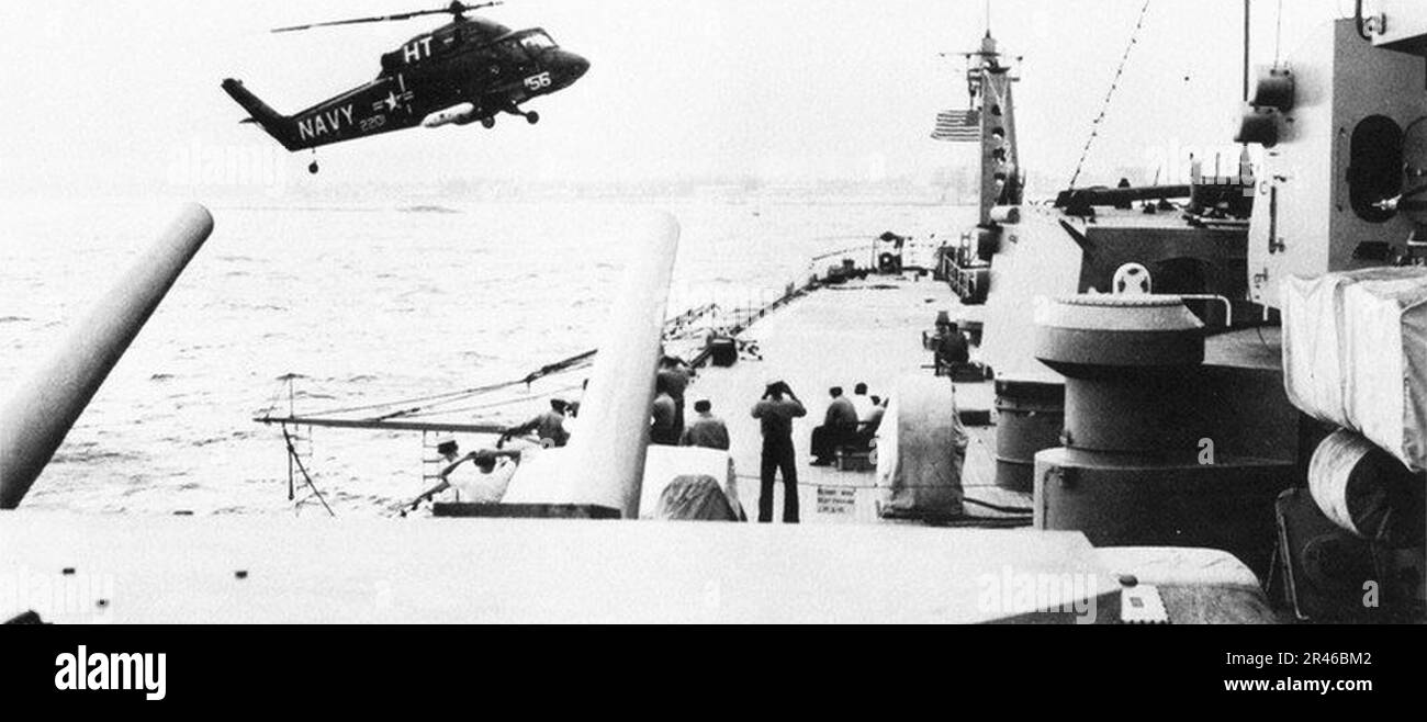 UH-2B Seasprite from HC-4 approaches USS Newport News (CA-148) in 1966 ...