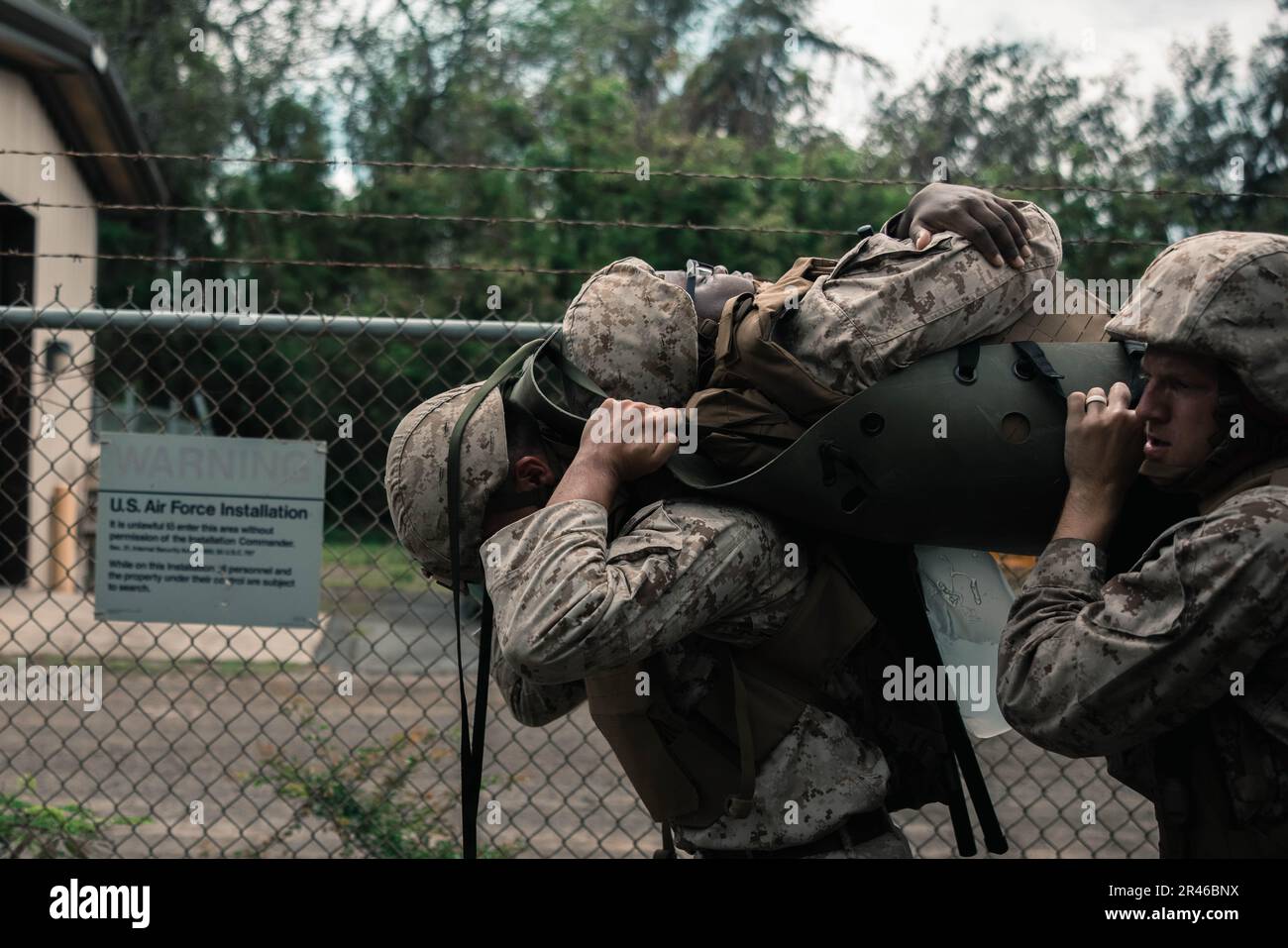 U.S. Marines stationed at Marine Corps Base Hawaii escort a simulated ...