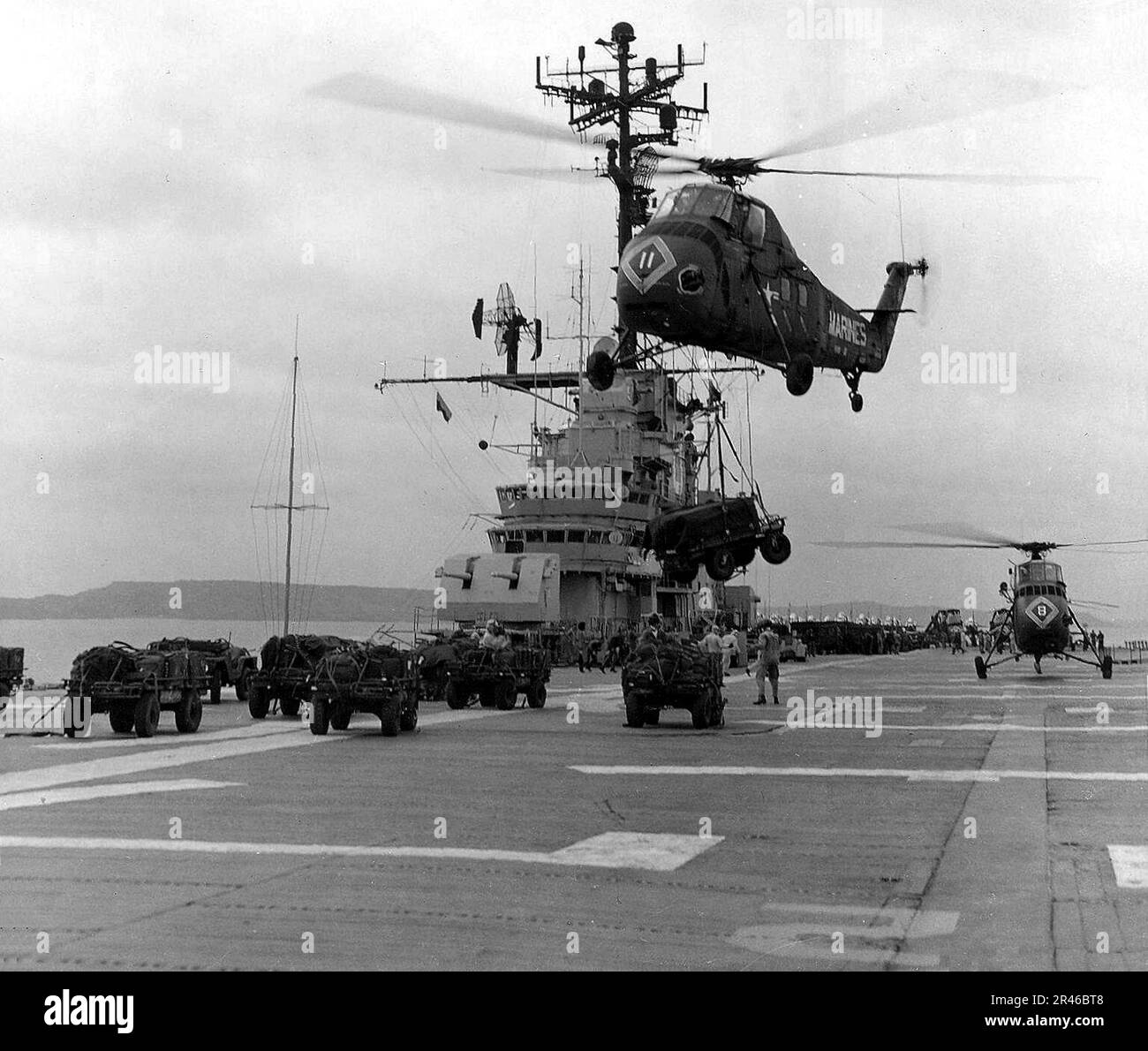 UH-34D lifts vehicle from USS Valley Forge (LPH-8) c1965 Stock Photo ...