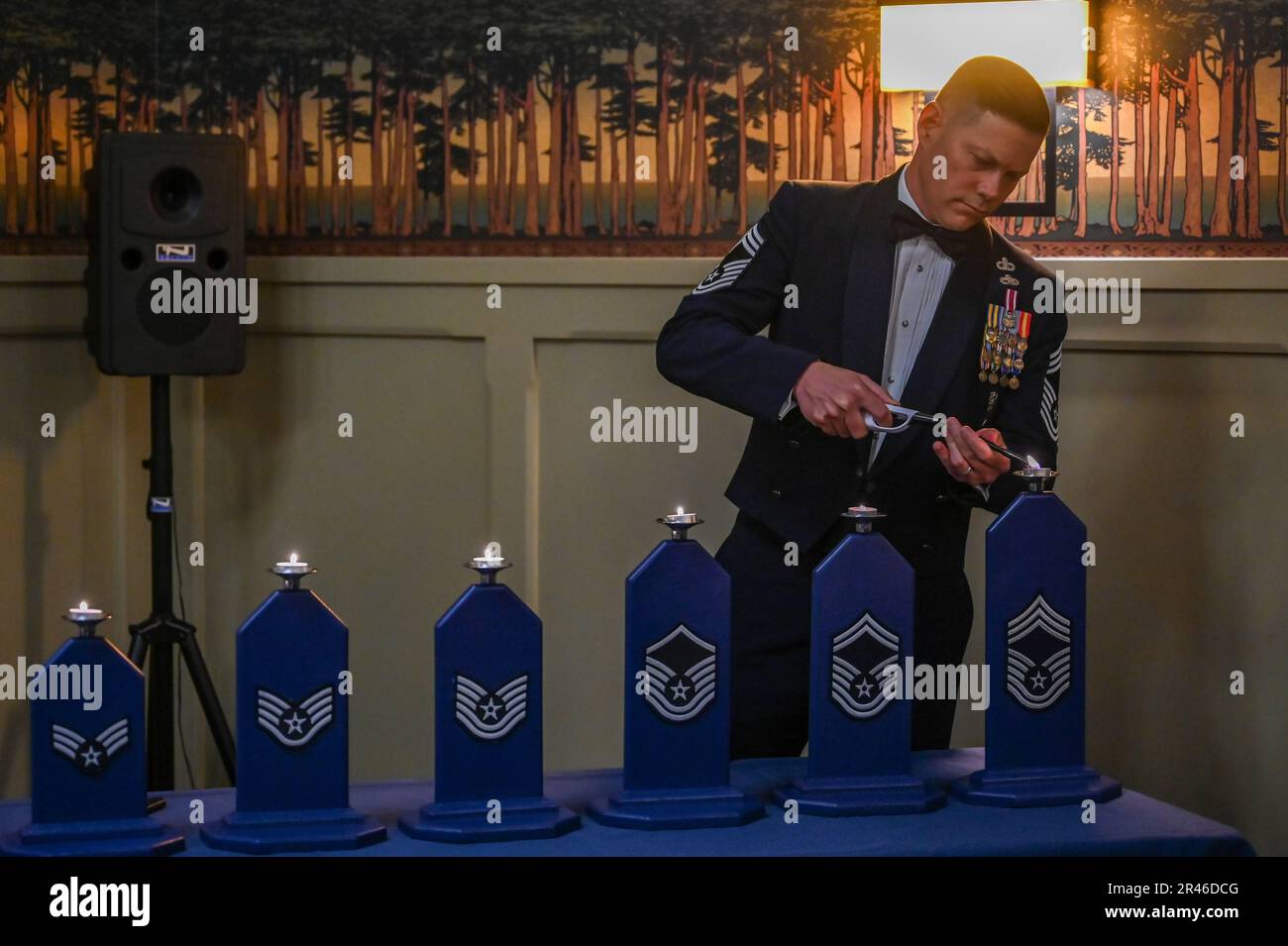 Chief Master Sgt. Brett Kemp, 649th Munitions Squadron, lights the ...