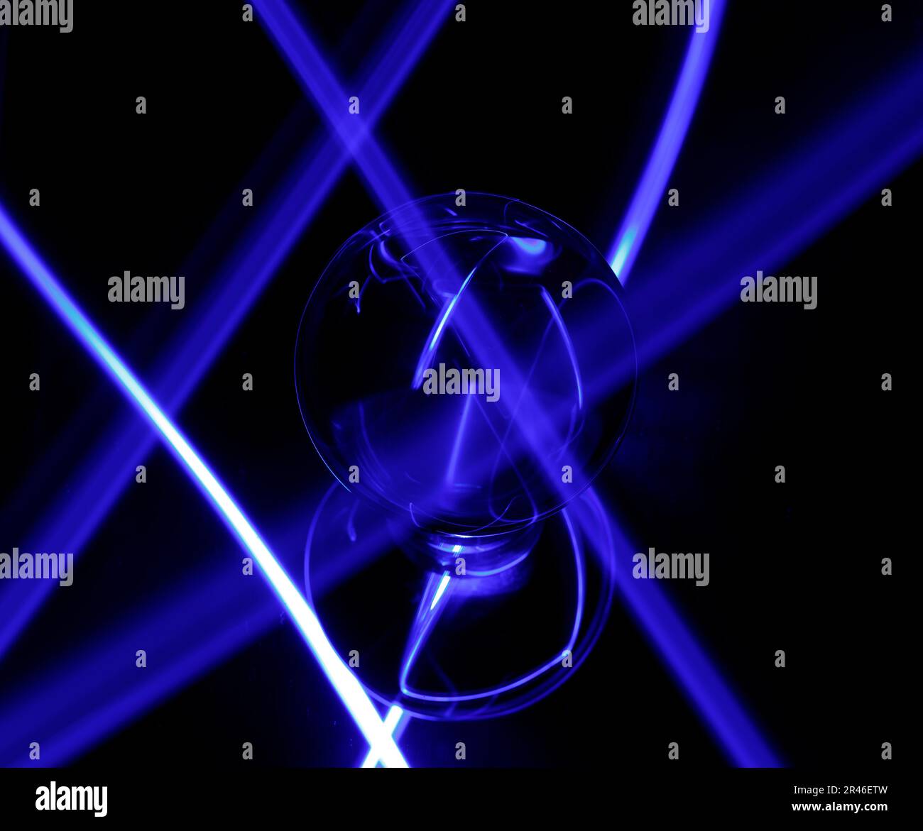 An intriguing ink blue light emanating from a light bulb in a dimly lit ...