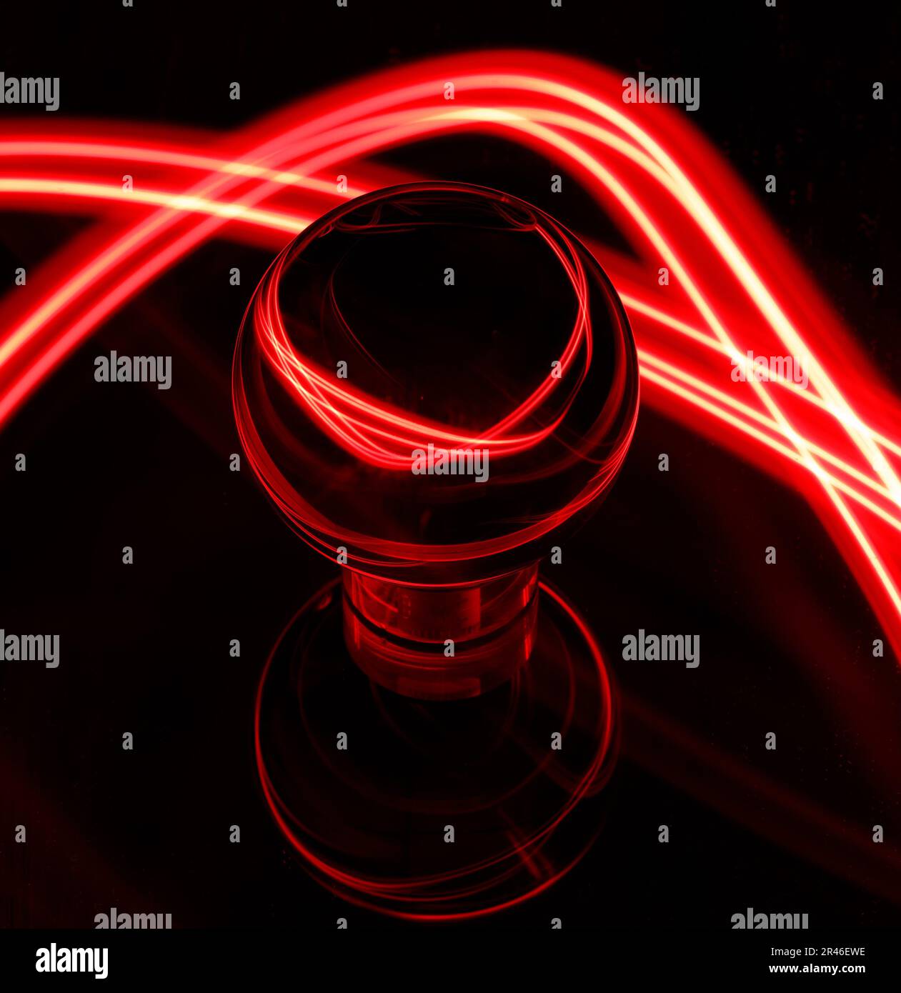 An intriguing red light emanating from a light bulb in a dimly lit ...