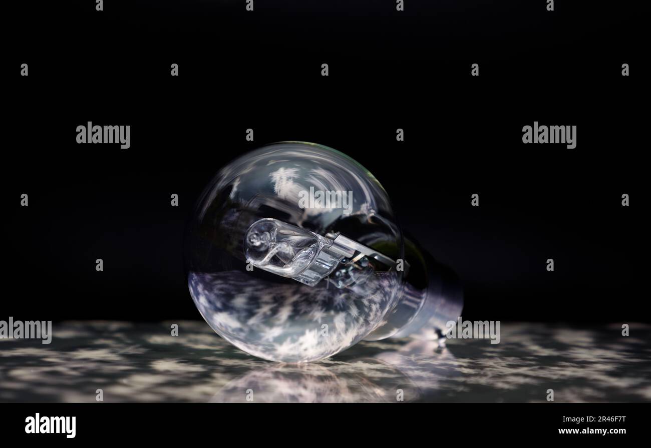 An intriguing light illuminating the light bulb in a dimly lit setting ...