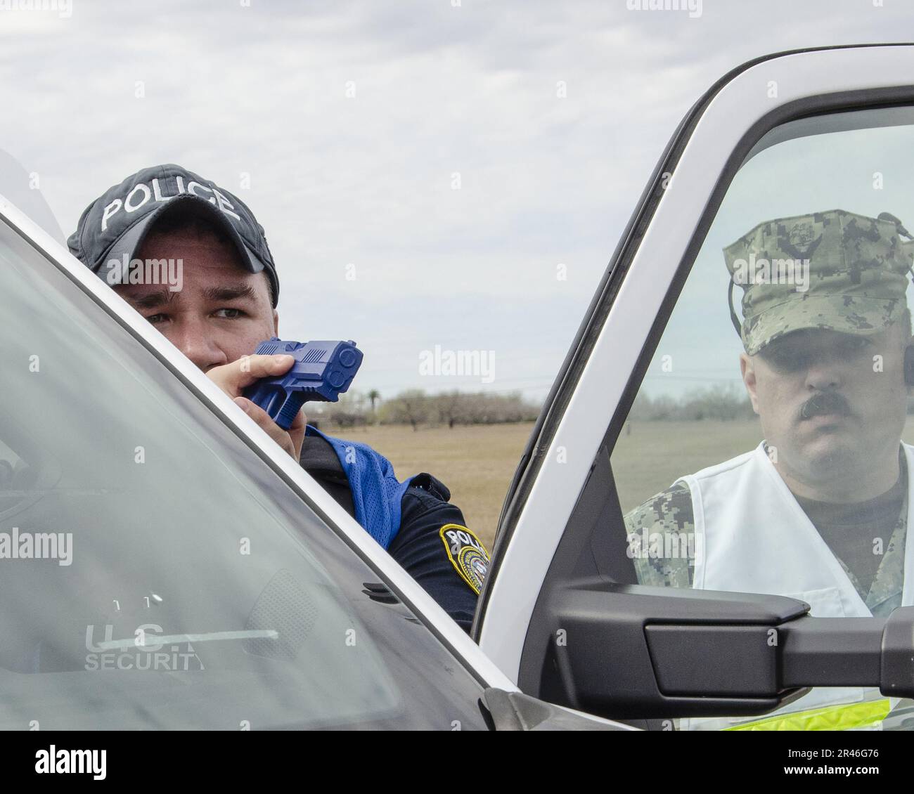 A Naval Air Station Kingsville training evaluator observes a security ...