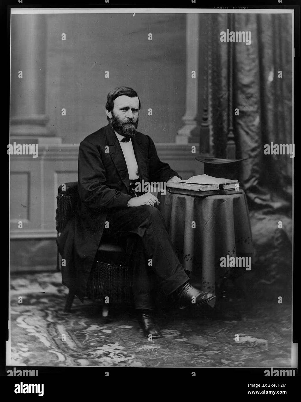 Ulysses S. Grant, full-length portrait, seated at table with books and ...
