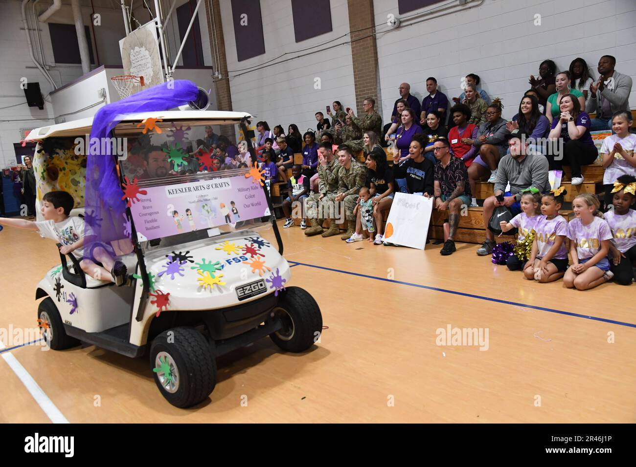 Decorated golf carts ride through the gym during a pep rally inside the ...
