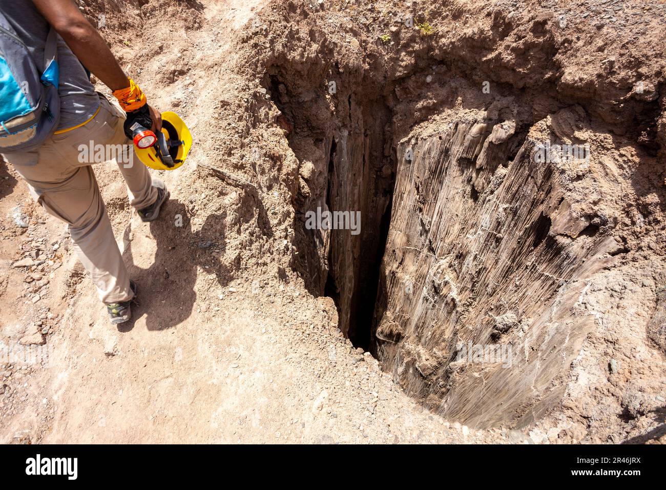 A large hole is eroded out of soft salt rock near Namakdan, a large ...