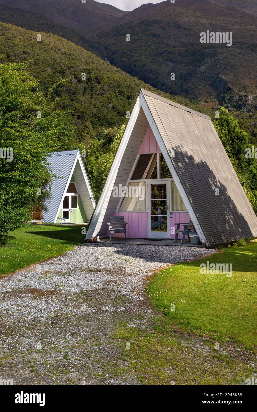 An idyllic scene of triangular-shaped homes in a lush park in Makarora ...