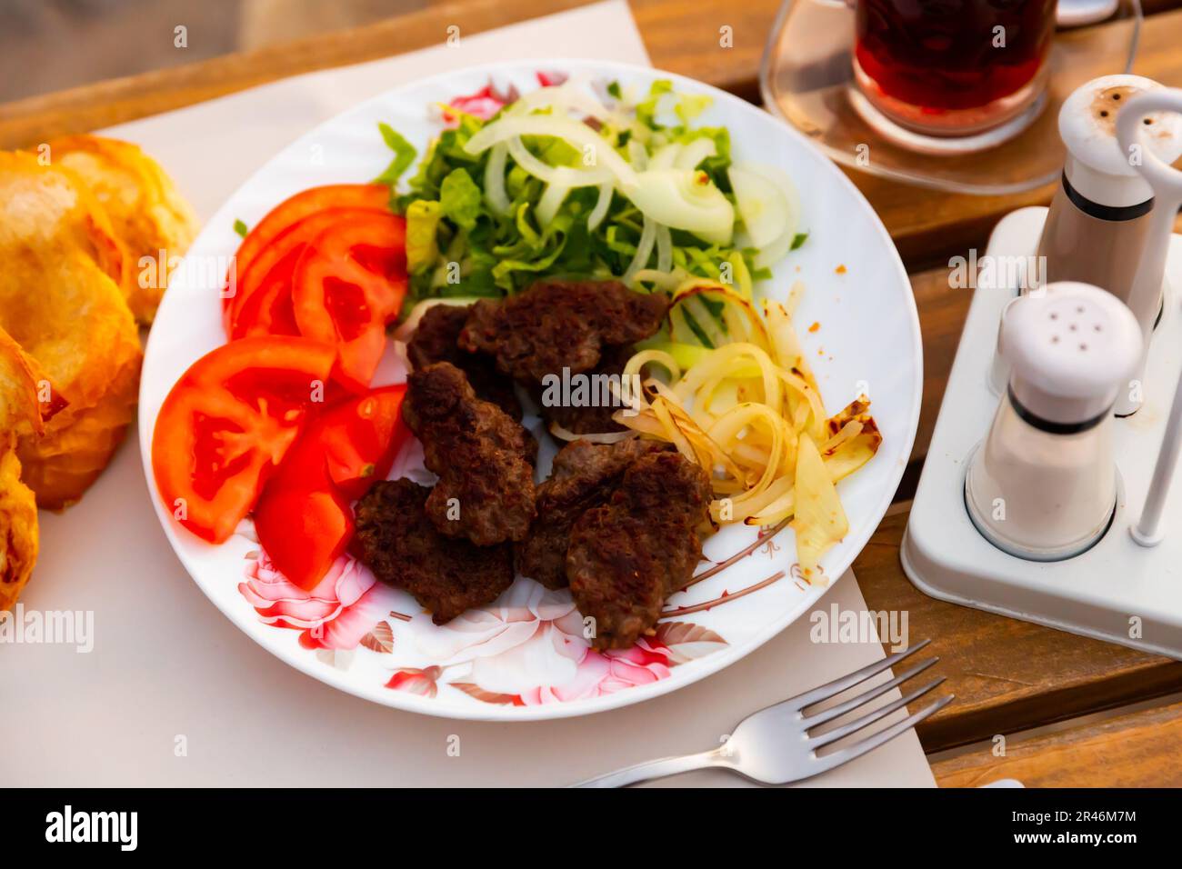 Grilled Turkish kofte from lamb with vegetable garnish Stock Photo - Alamy