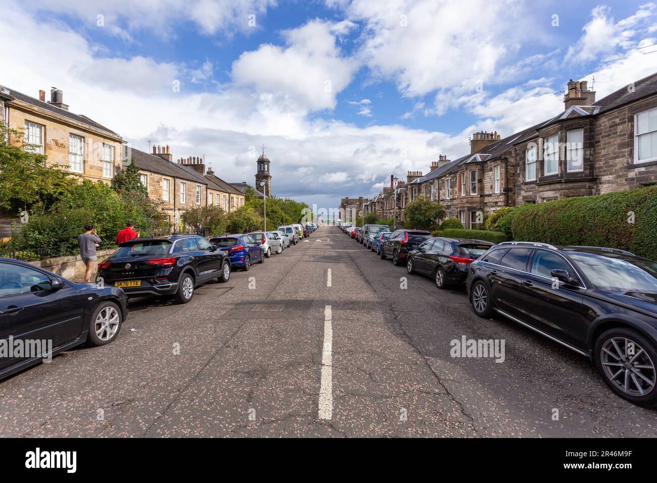A narrow residential street with cars parked alongside it in Edinburgh ...