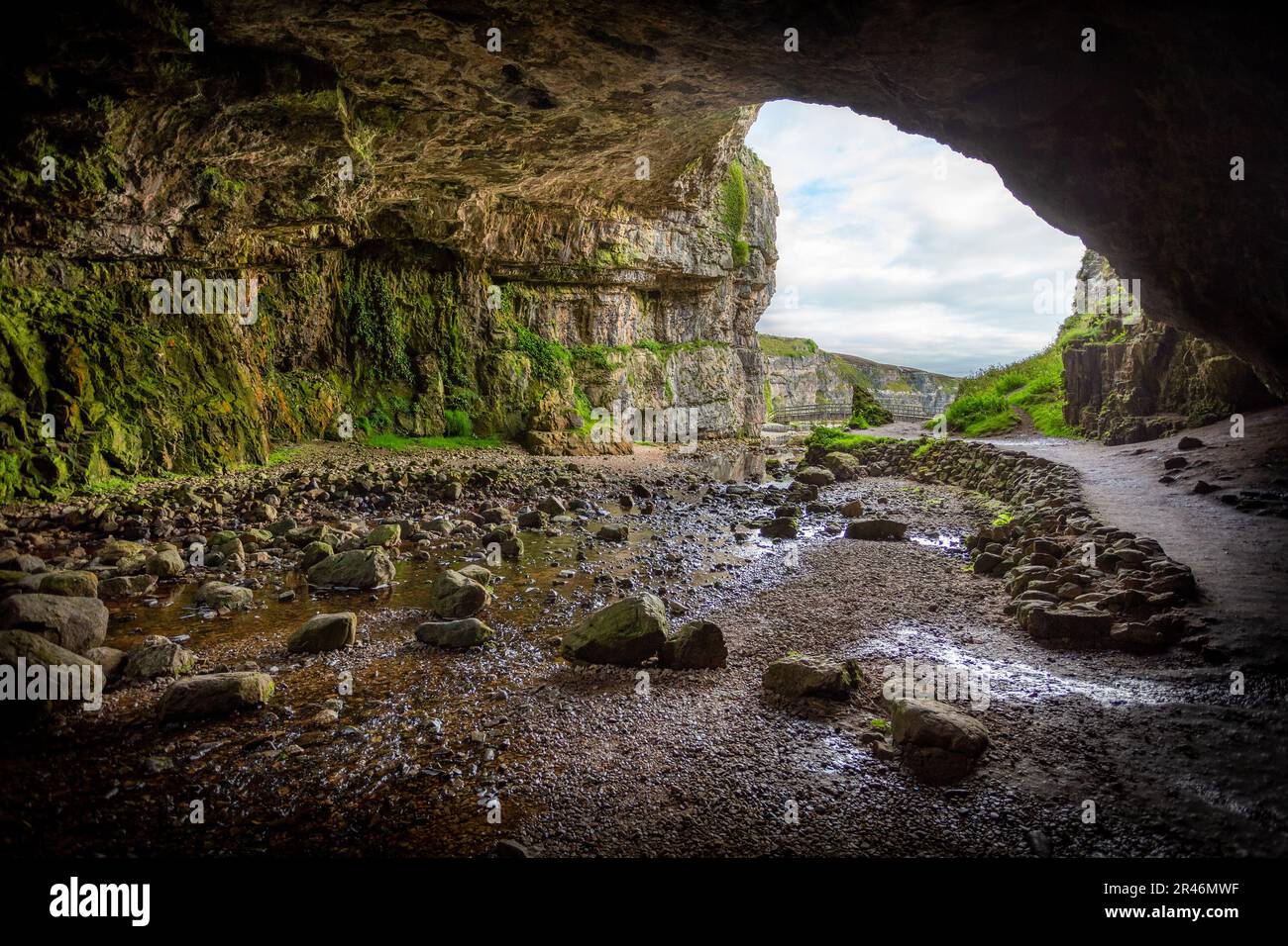 The stunning Smoo cave with a deep pool of crystal clear water in ...