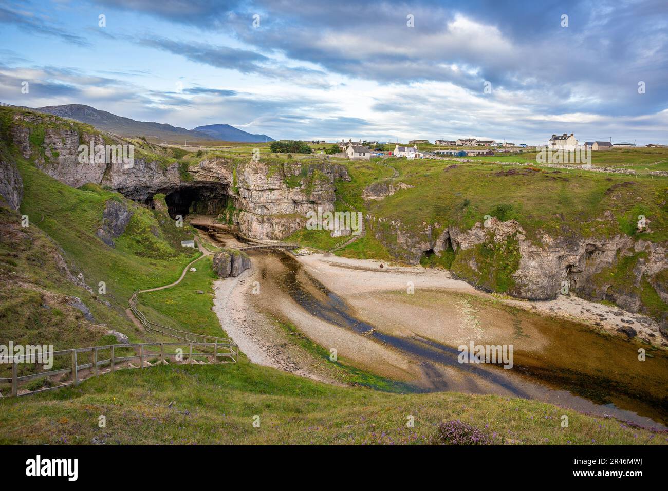 The stunning Smoo cave with a pool of crystal clear water in Durness ...